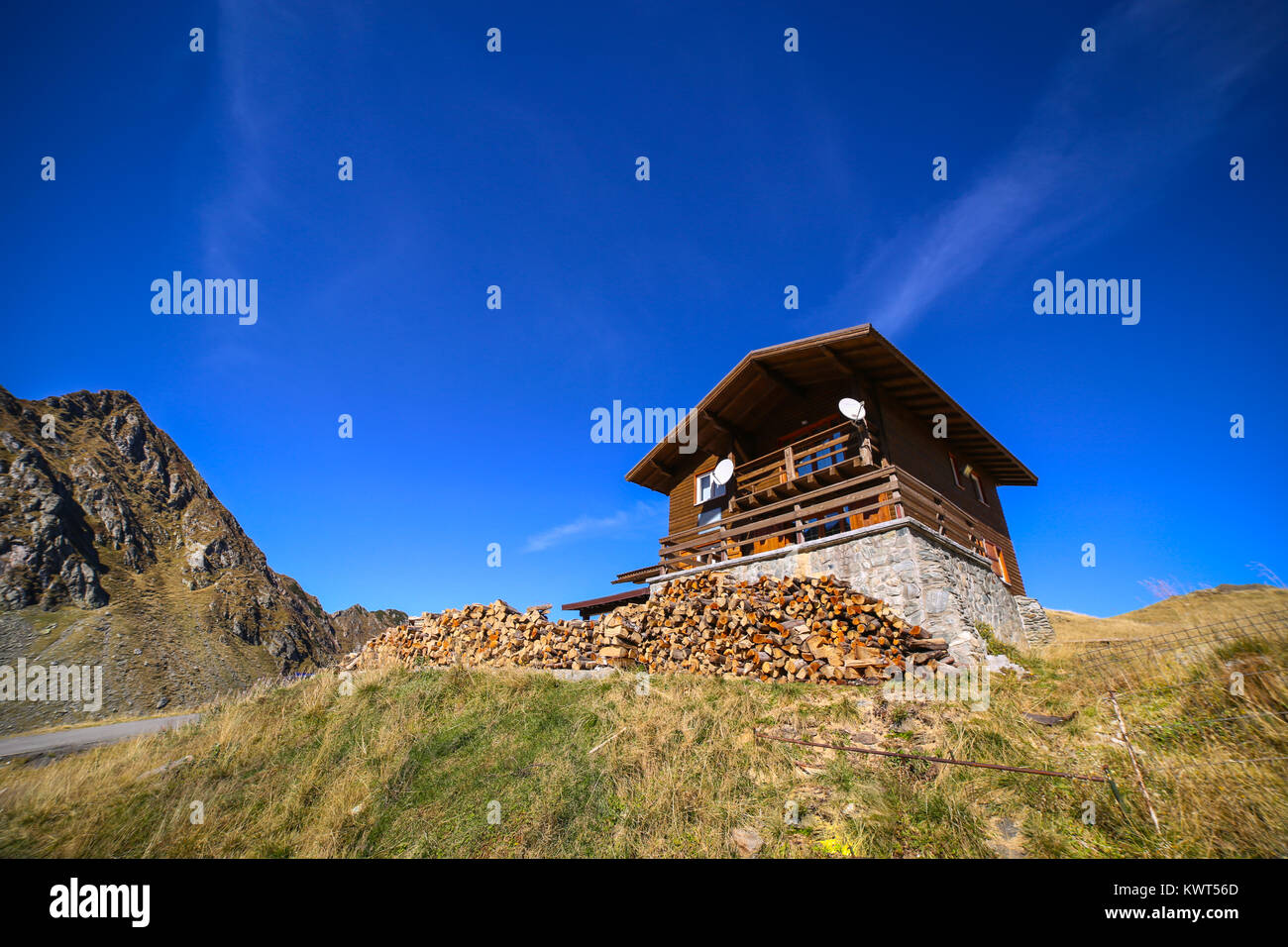 Autumn landscape with cabin and Fagaras mountains in the background at ...