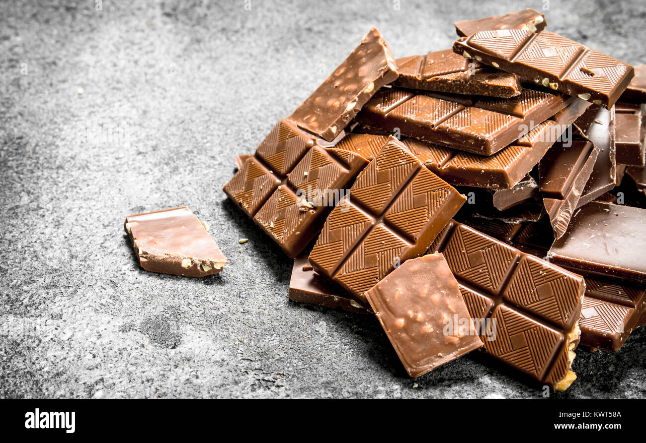 Broken chocolate bars. On a rustic background Stock Photo - Alamy