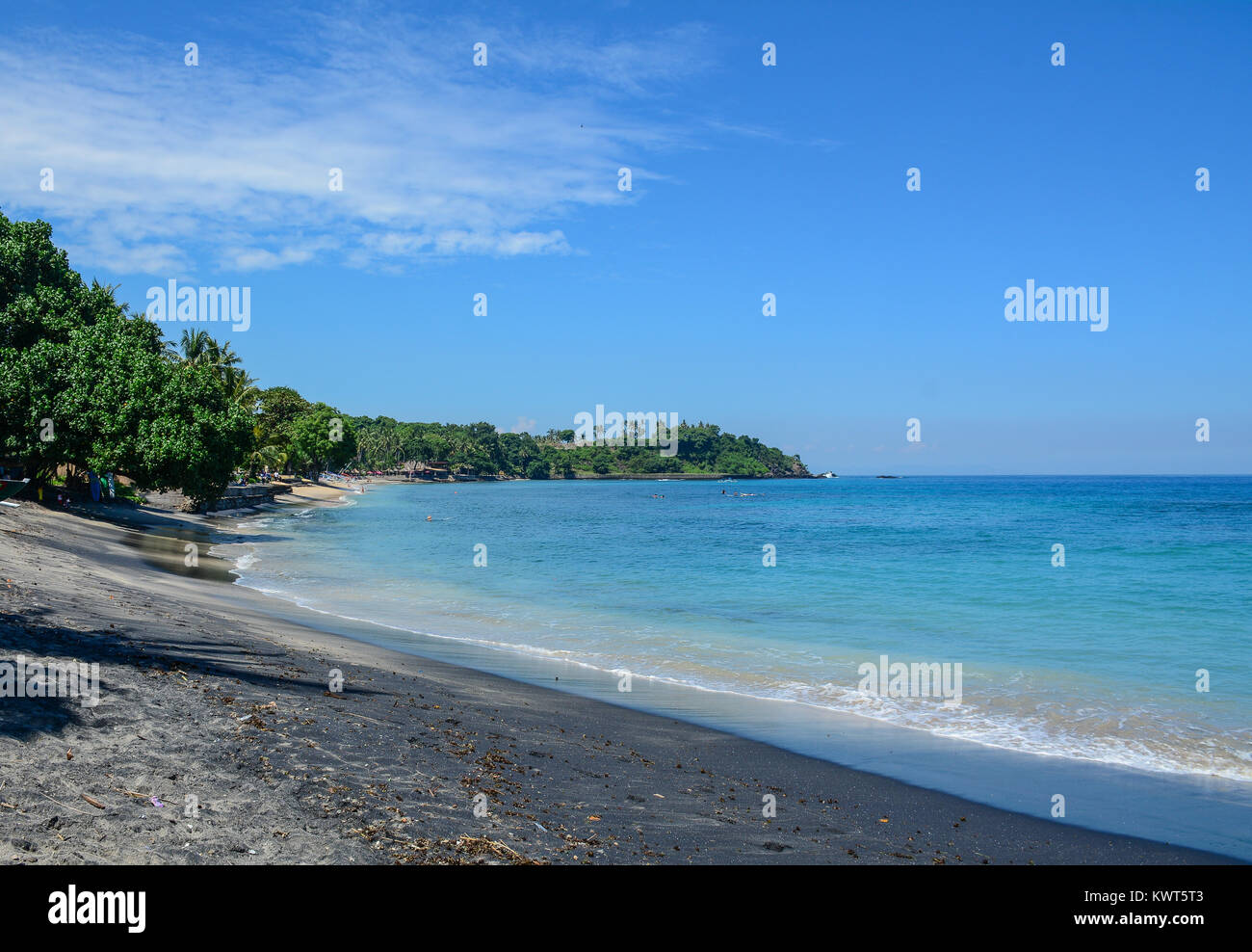 Black sand beach with blue sea on Lombok Island, Indonesia Stock Photo ...