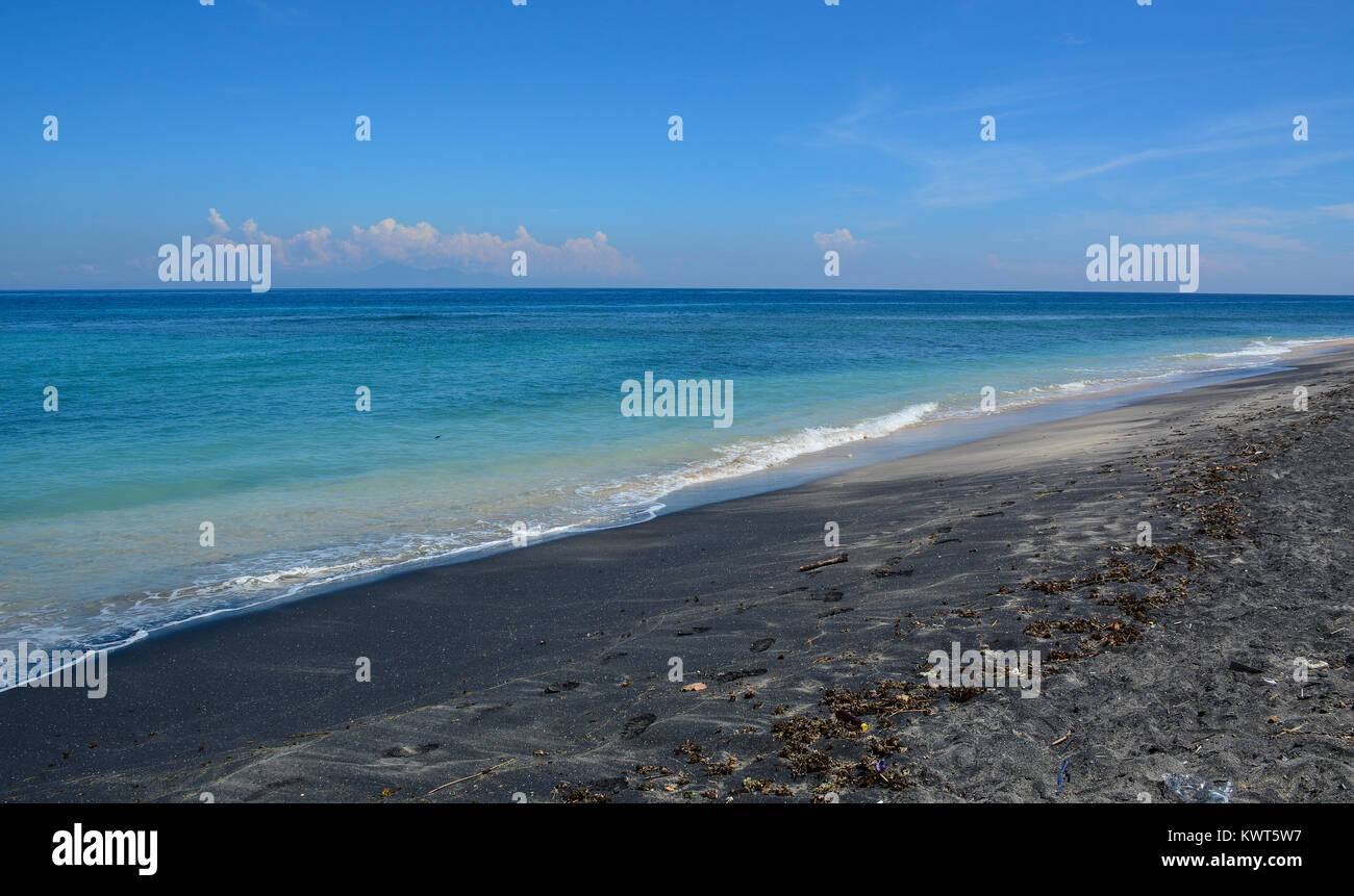 Black sand beach with blue sea at summer on Lombok Island, Indonesia ...