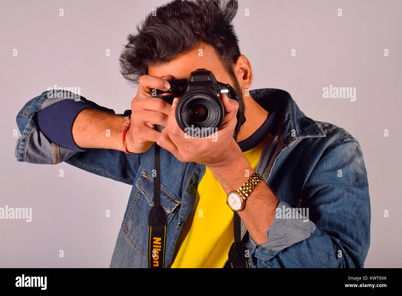 Young male model posing with professional camera, Pune, Maharashtra ...