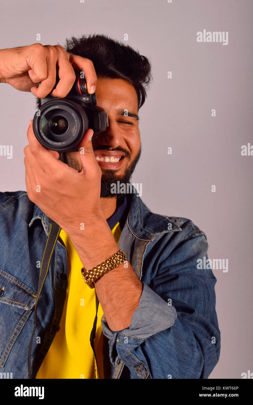 Young male model posing with professional camera, Pune, Maharashtra ...
