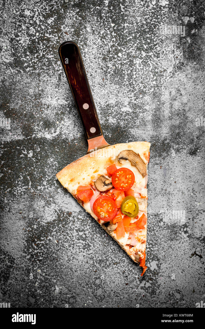 piece of fresh pizza. On a rustic background Stock Photo - Alamy