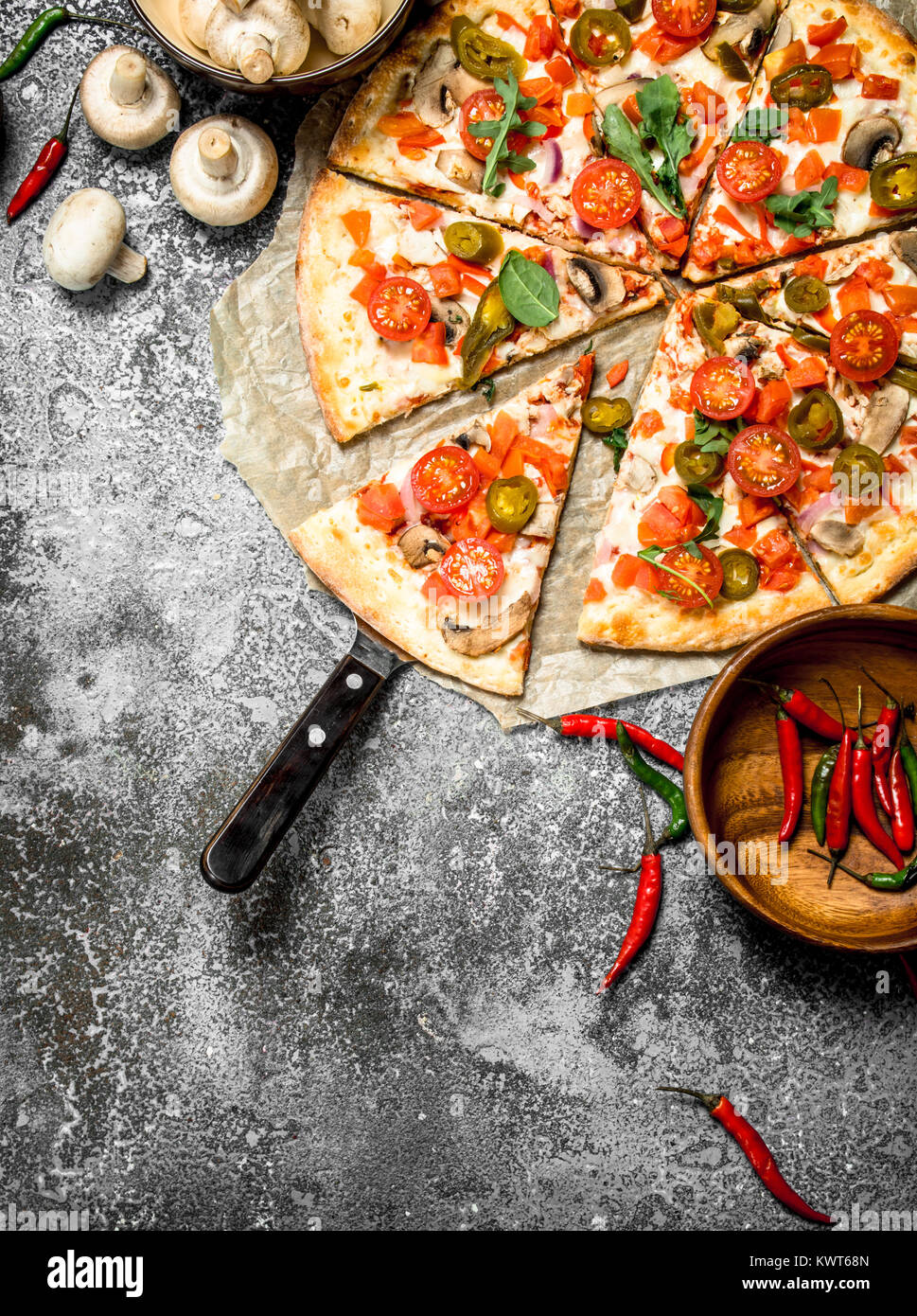 Mexican pizza with hot peppers. On a rustic background Stock Photo - Alamy