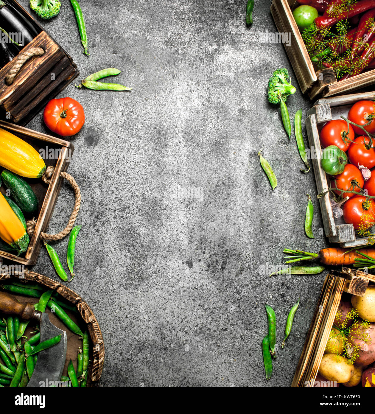 Organic food. Fresh crop of vegetables in boxes. On a rustic background ...