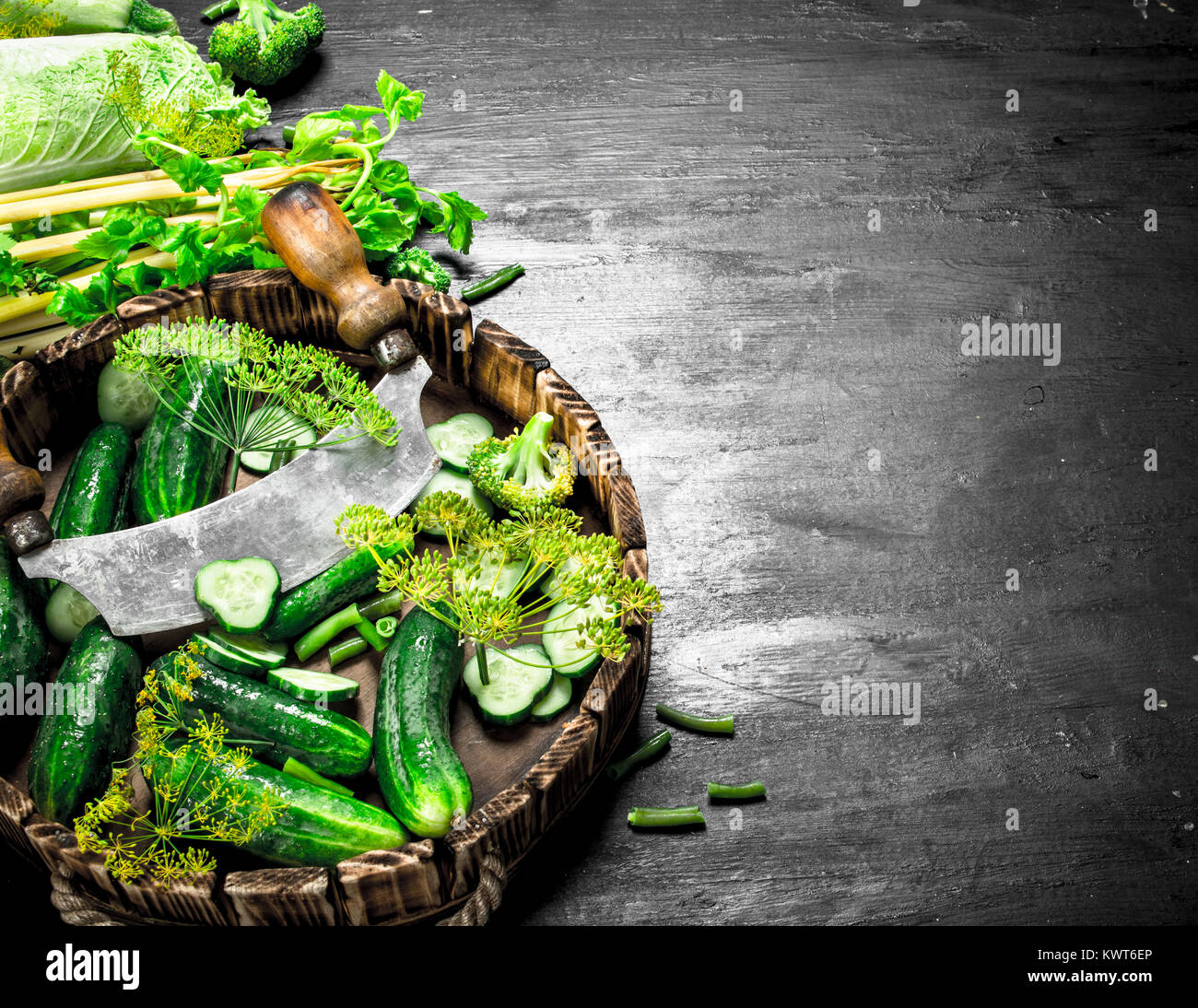 Organic food. Fresh cucumbers with herbs. On the black chalkboard Stock ...