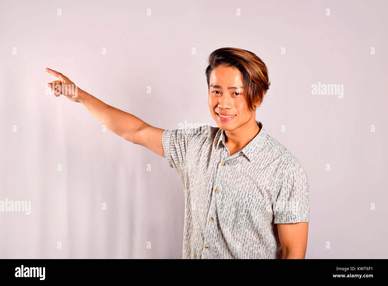 Indian male pointing at something with a happy expression, Pune ...