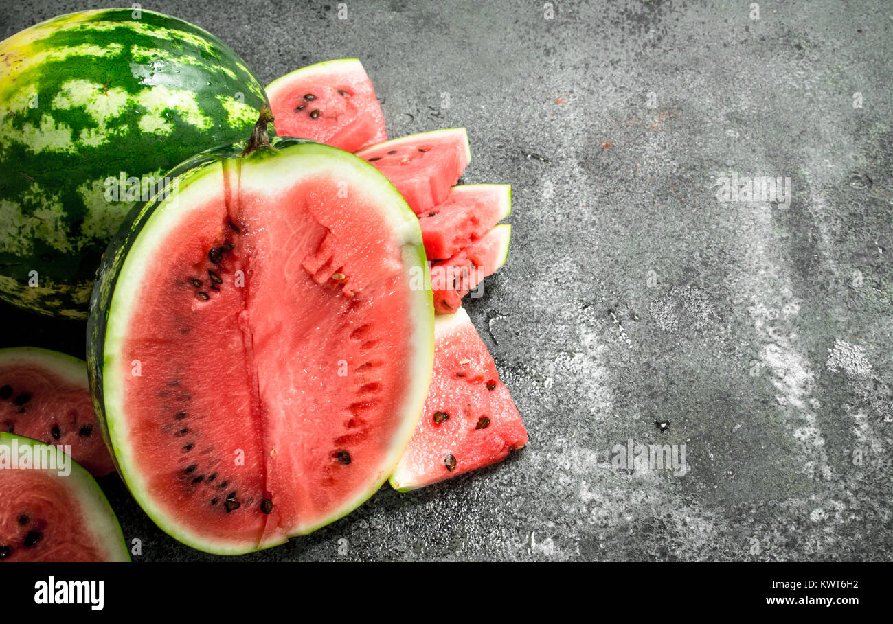 Fresh slices of watermelon. On a rustic background Stock Photo - Alamy