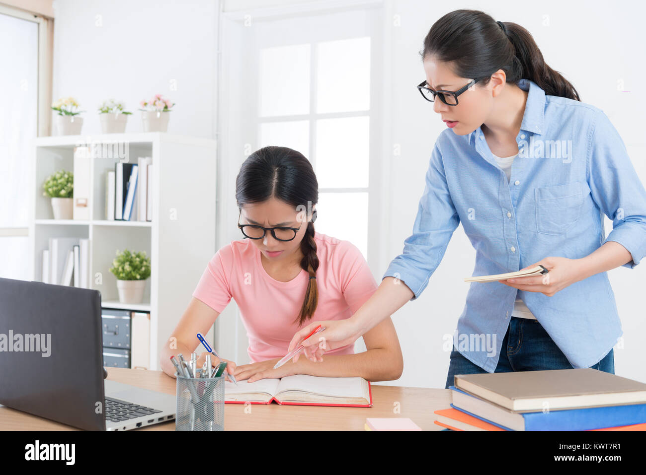 sad elegant girl student writing studying exam test book having problem ...