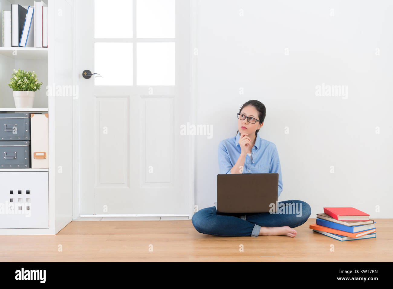 young pretty college student girl thinking how to do school homework ...