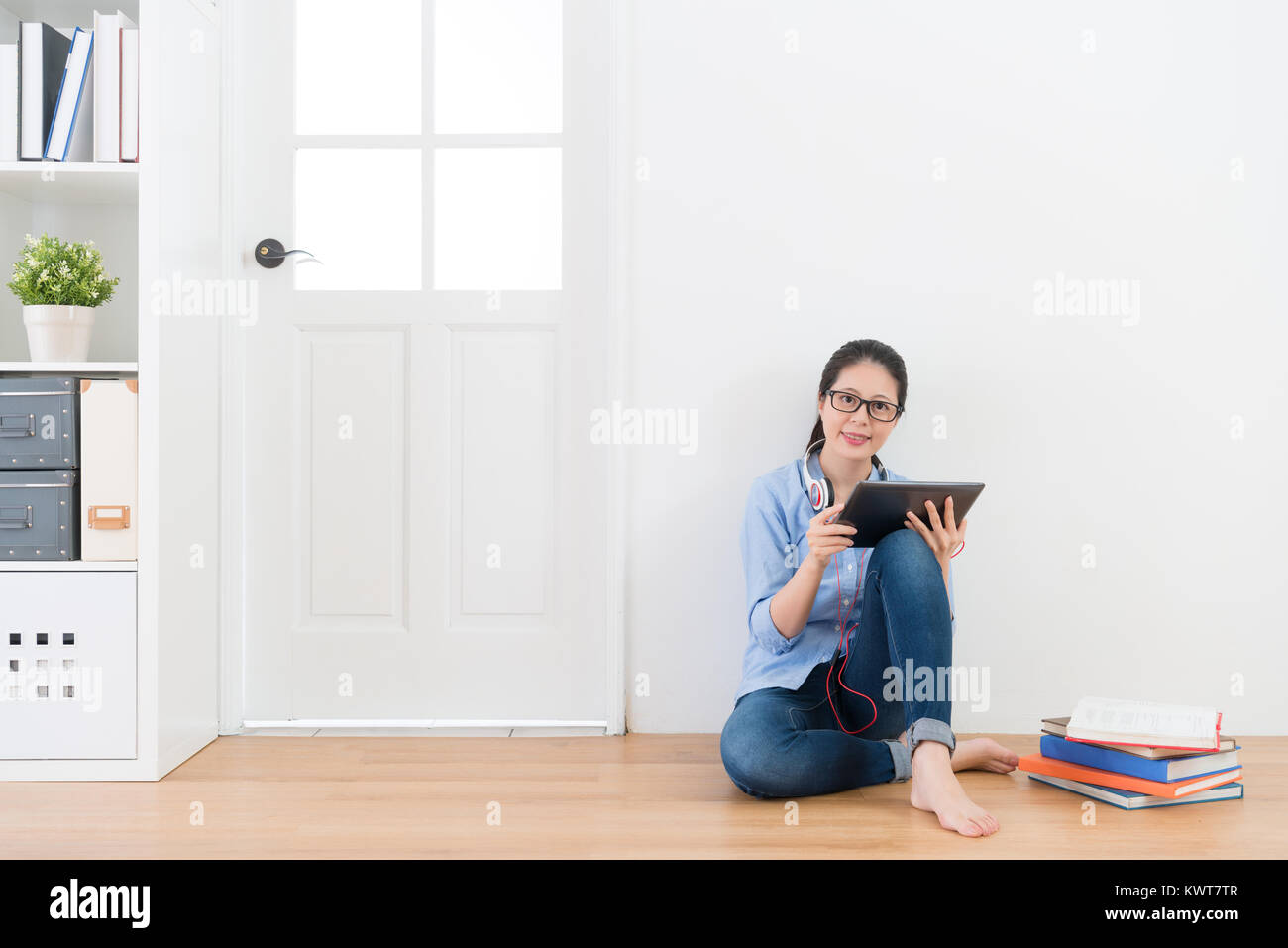 beautiful young female student using computer studying with online e ...