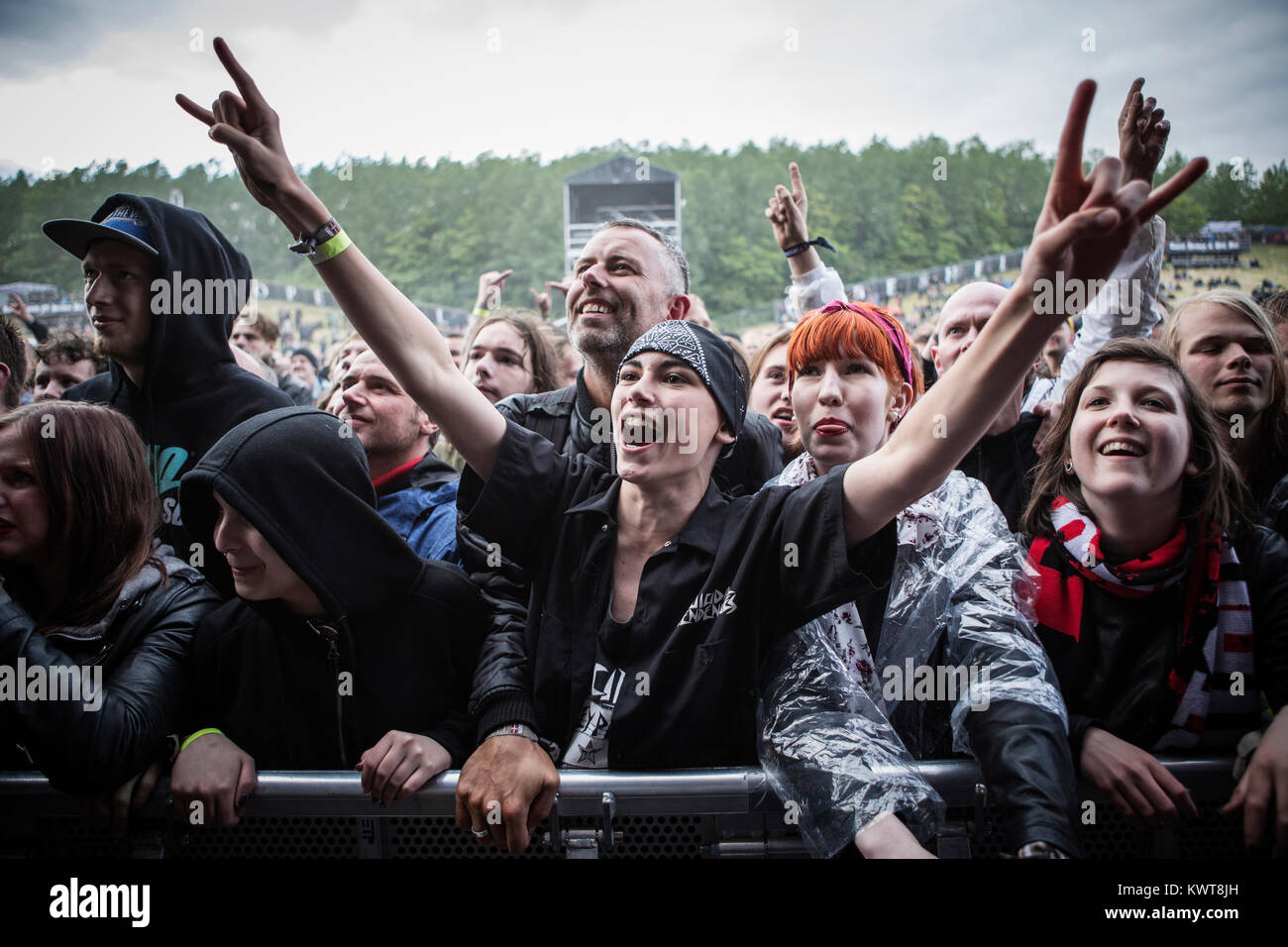 Enthusiastic and energetic heavy metal fans headbang, shout out loud ...