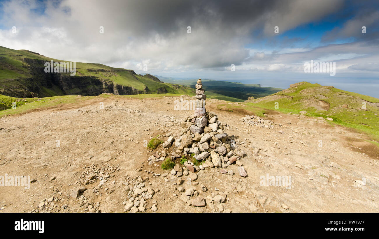 A stone cairn has been built by hikers summiting a small mountain near ...