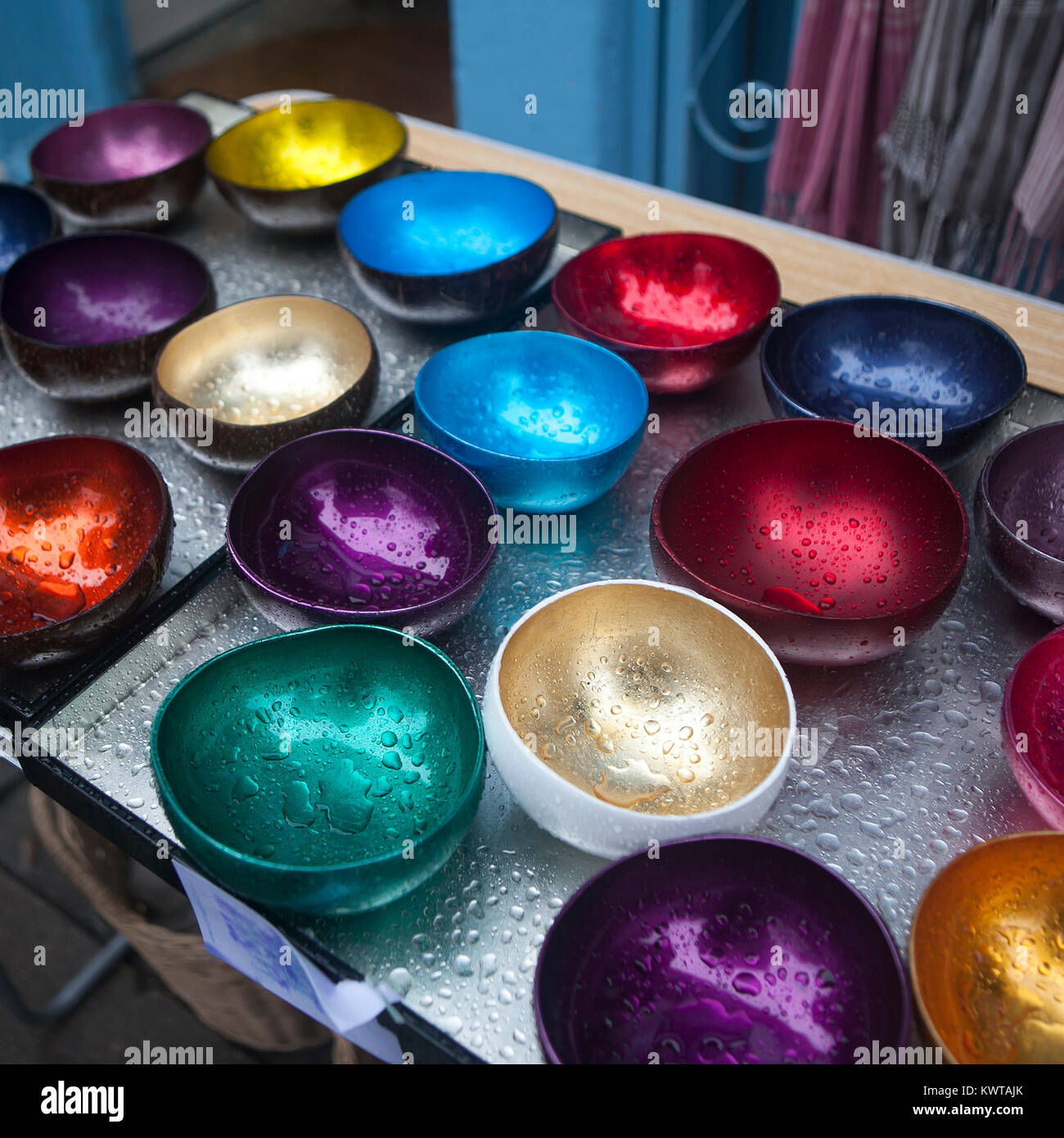 the Multicolored bowls of coconut shell with rain drops Stock Photo - Alamy