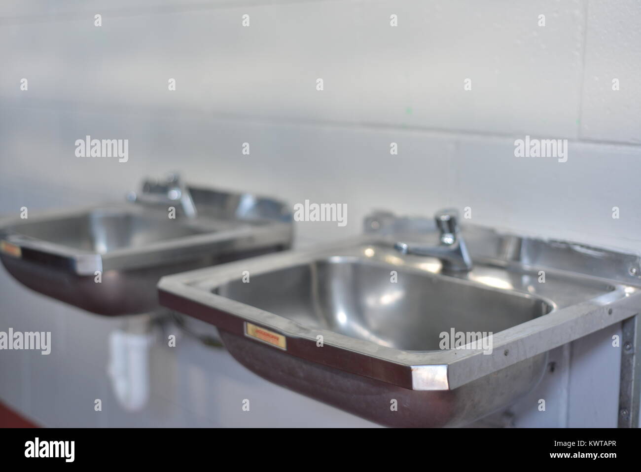Stainless steel sinks in a public toilet hi-res stock photography and ...