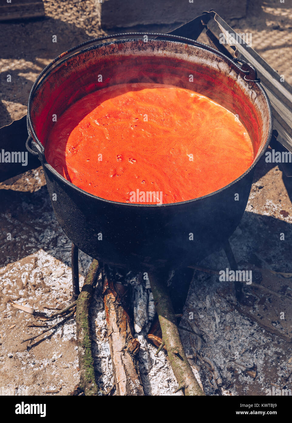Preparing traditional romanian tomato juice/sause in caldron, boiled ...