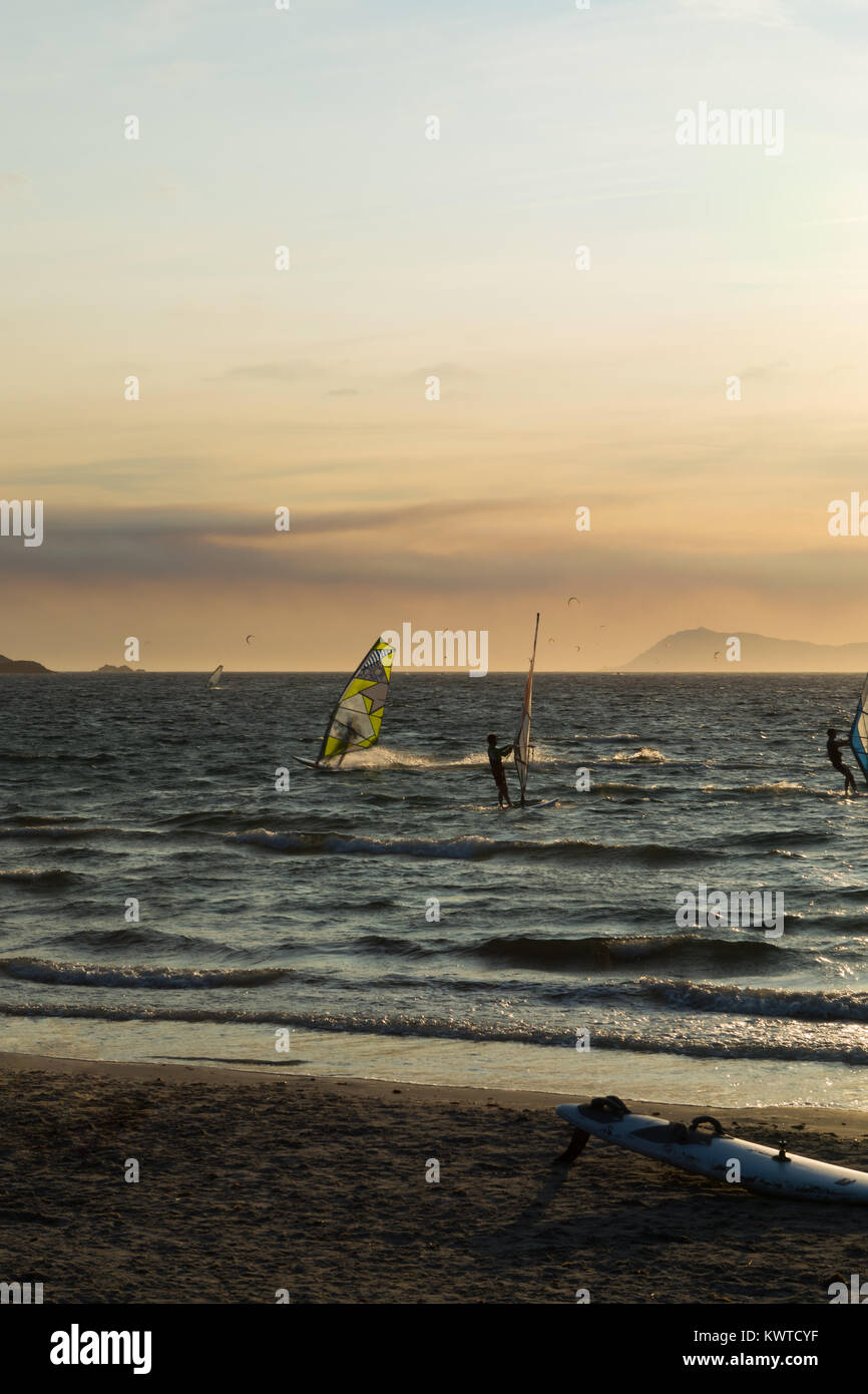Sunset over the sea or ocean and extreme freestyle sport windsurfing ...