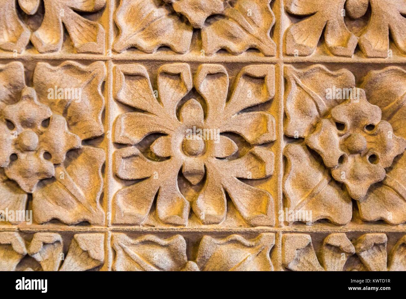 Wall or screen of carved stone depicting flower motif patterns Stock ...