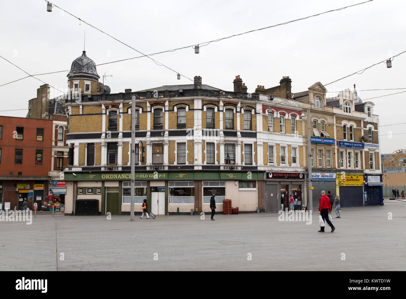 A pub and shops at Woolwich in London, England. The area is in east ...