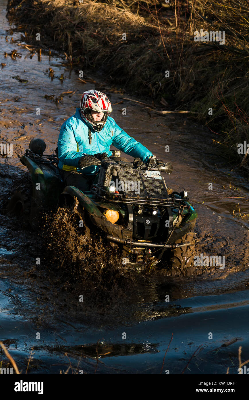 Lviv,Ukraine- December 6, 2015: Unknown rider on ATV overcomes a water ...