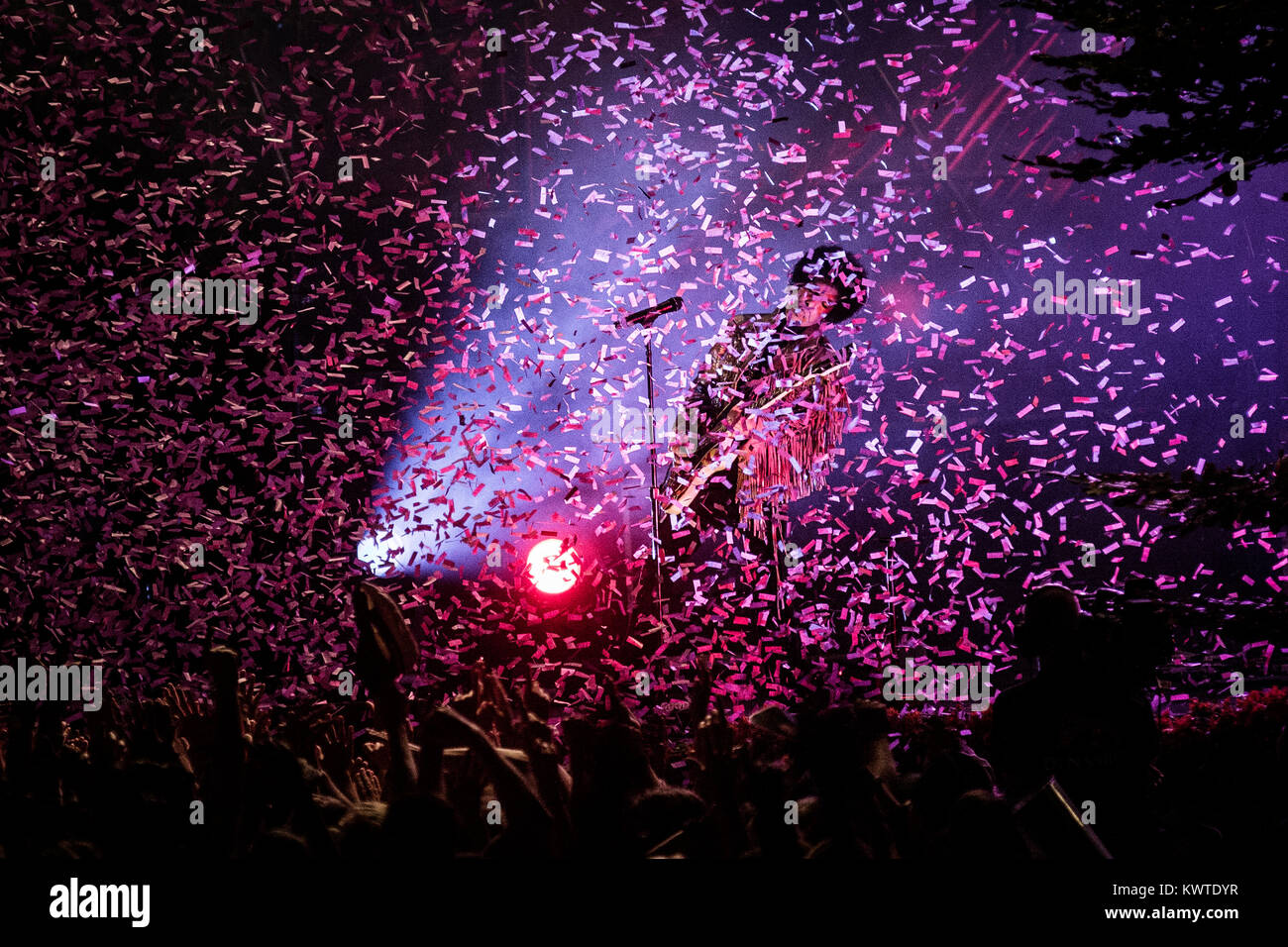 Singer and musician Prince plays a guitar solo while confetti (of ...