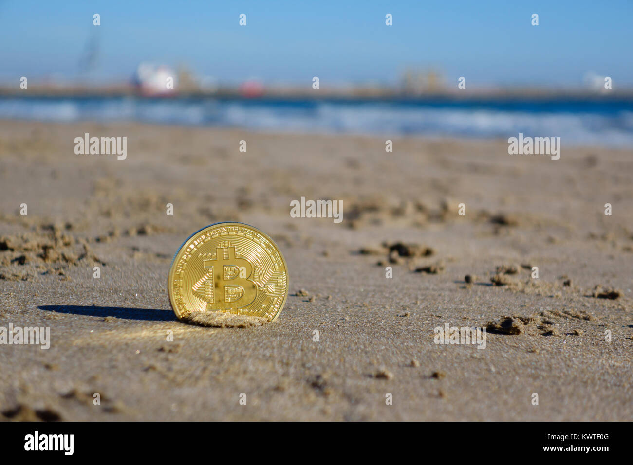 Golden bitcoin currency at the beach Stock Photo - Alamy