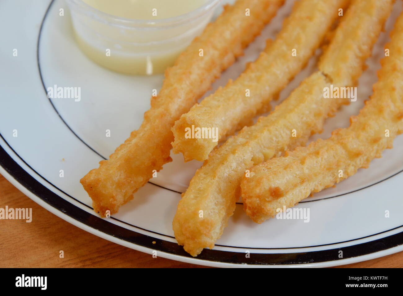 Churros Spanish deep fried dough stick on plate Stock Photo - Alamy