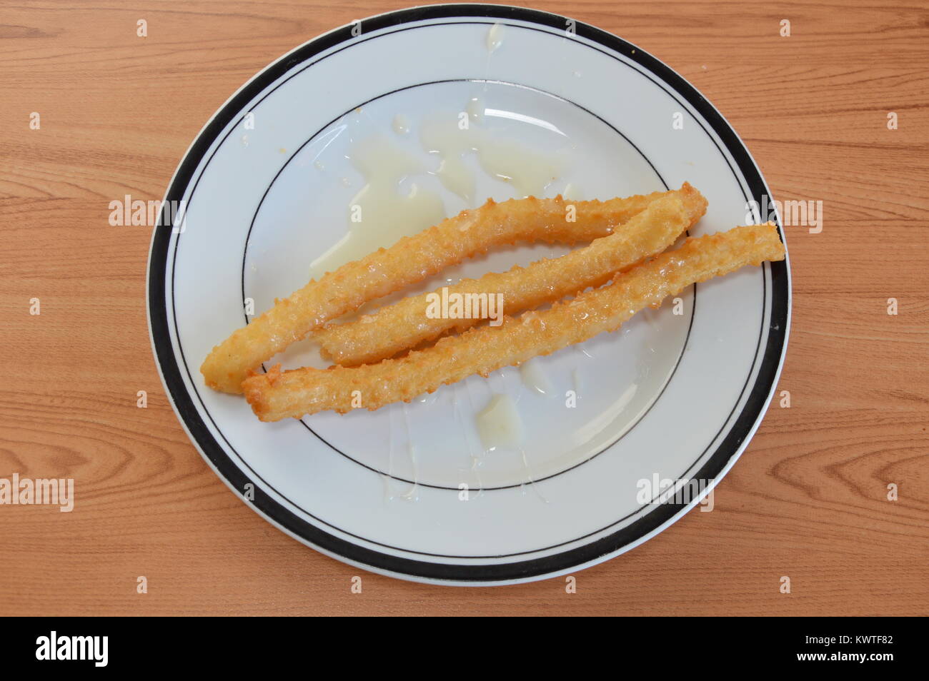 Churros Spanish deep fried dough stick on plate Stock Photo - Alamy