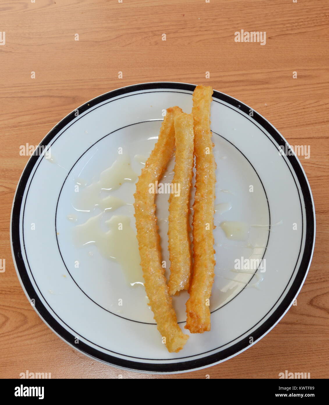 Churros Spanish deep fried dough stick on plate Stock Photo - Alamy