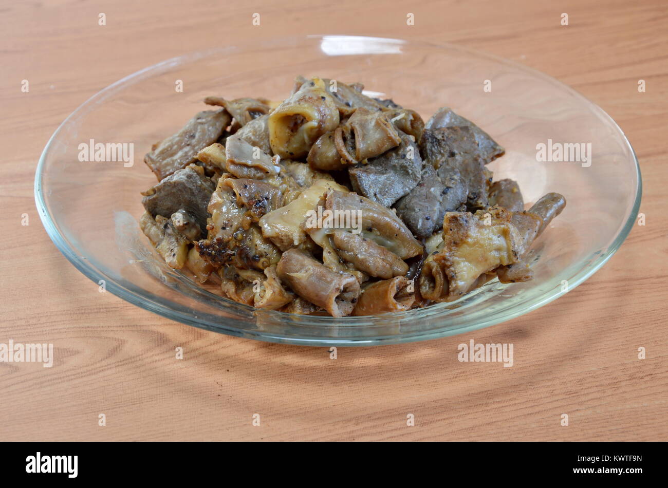 fried pork entrails with garlic on glass plate Stock Photo - Alamy