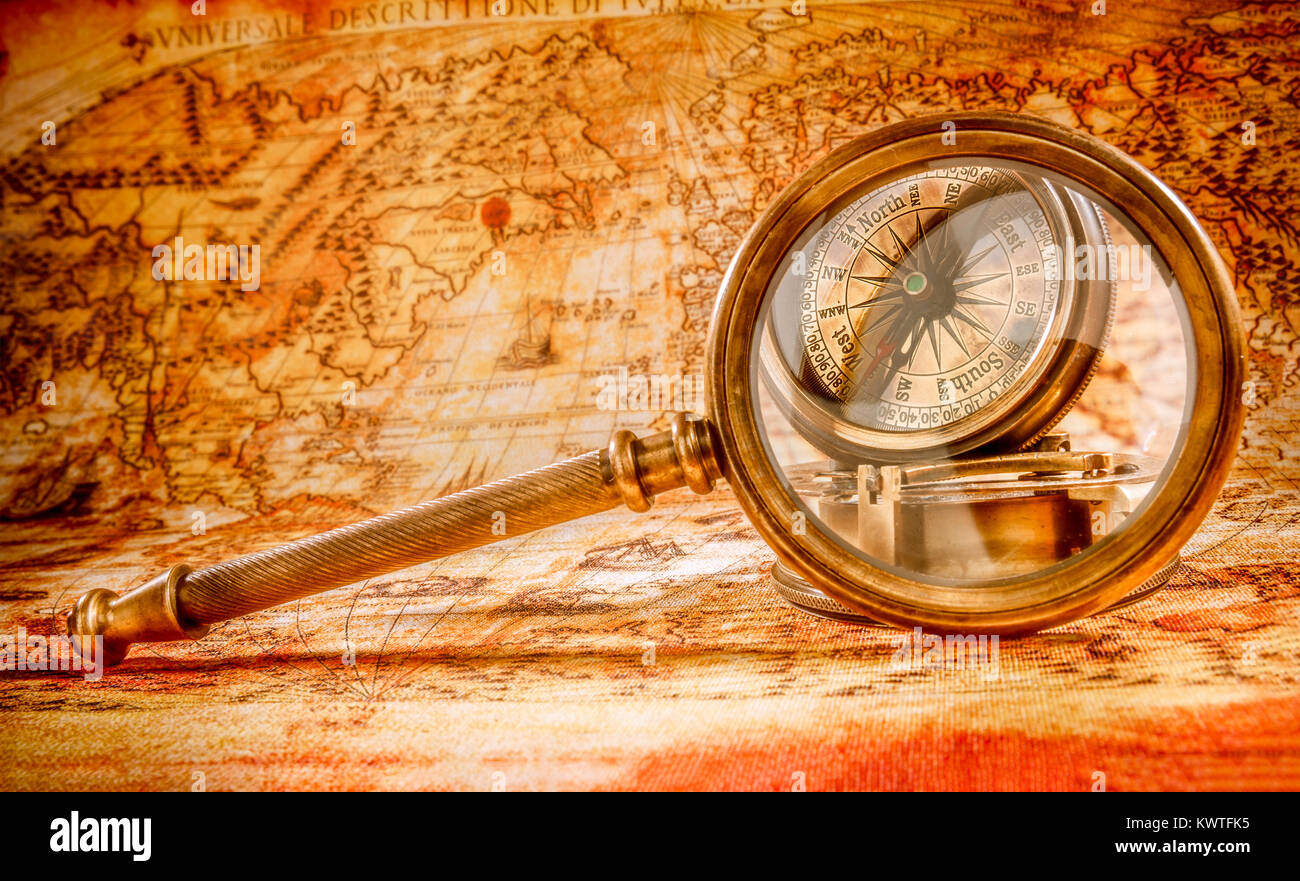 Vintage still life. Vintage magnifying glass lies on an ancient world ...