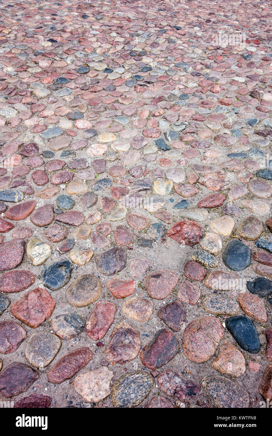 Old European irregular cobblestones of various shapes and sizes in ...