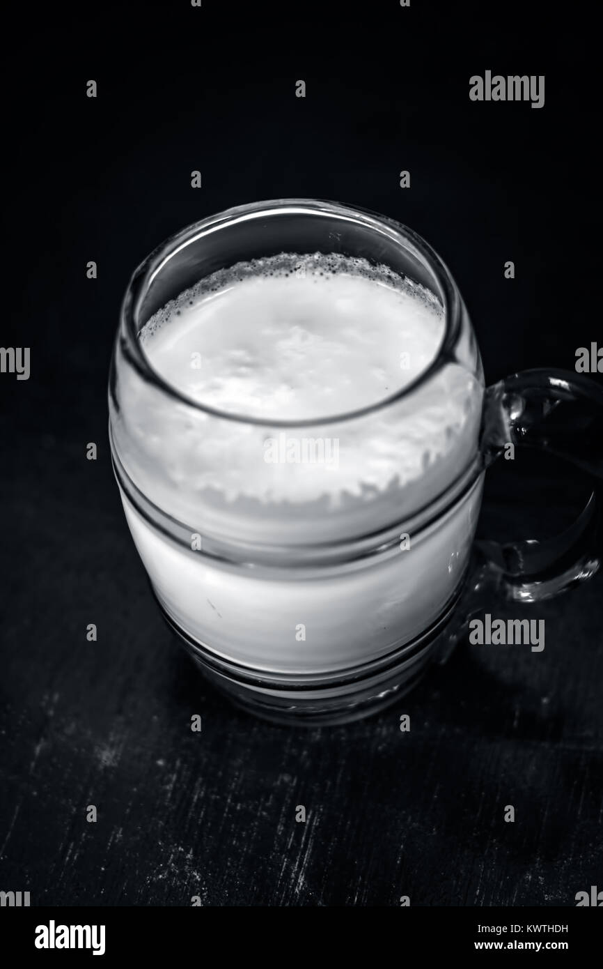Unsweetened milk in a transparent glass on wooden surface Stock Photo ...