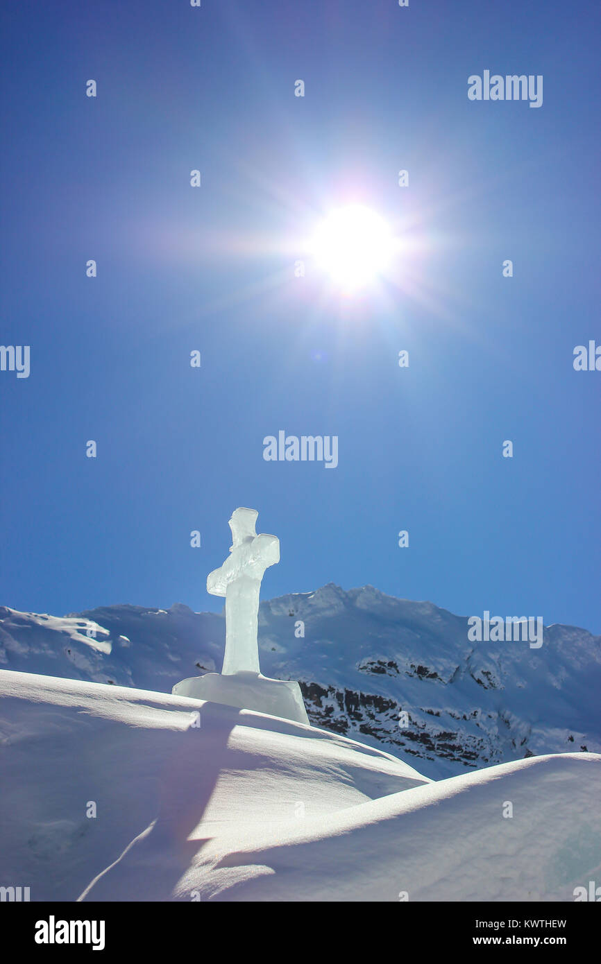 Cross christian symbol made from a block of ice on top of the ice ...