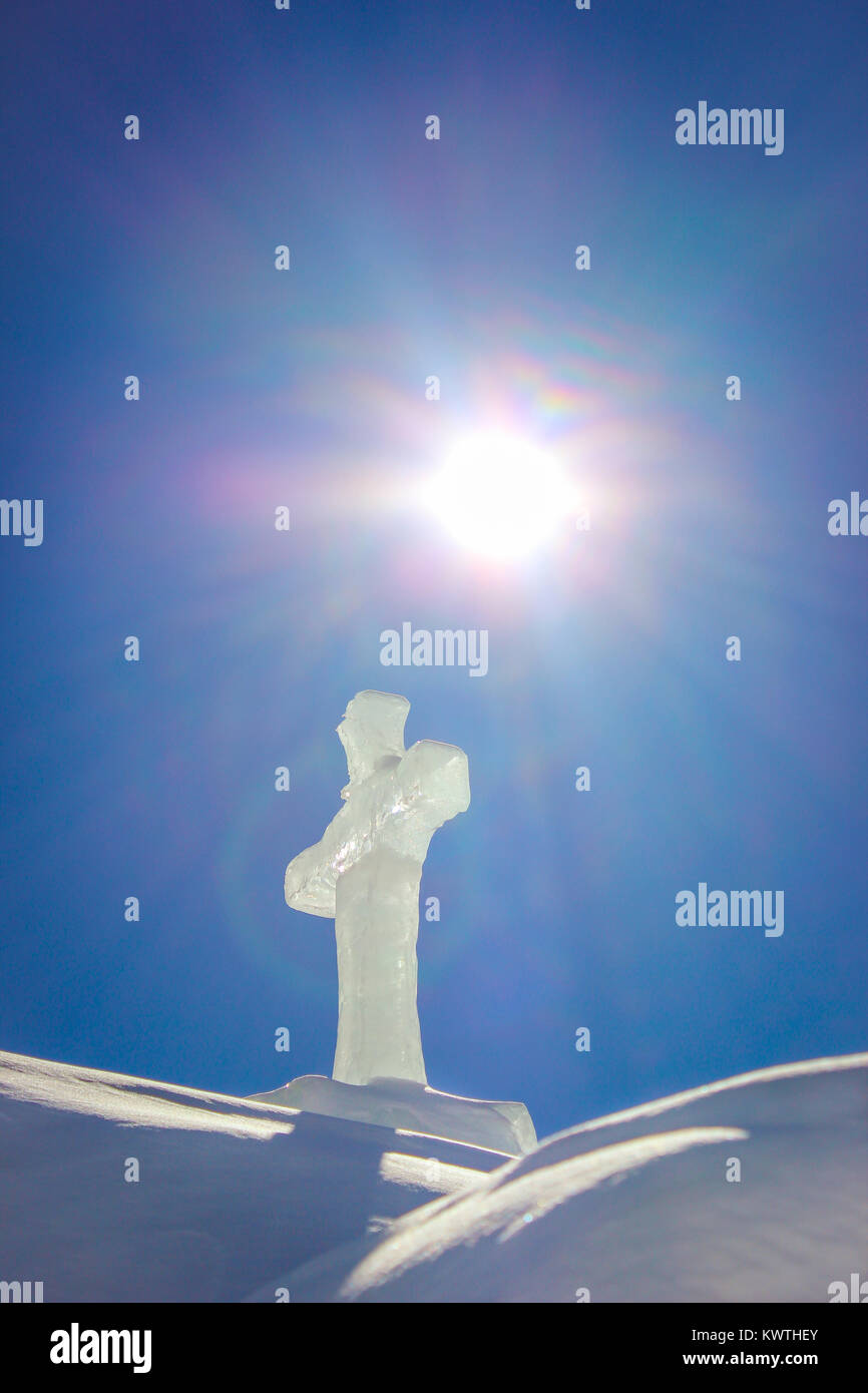 Cross christian symbol made from a block of ice on top of the ice ...