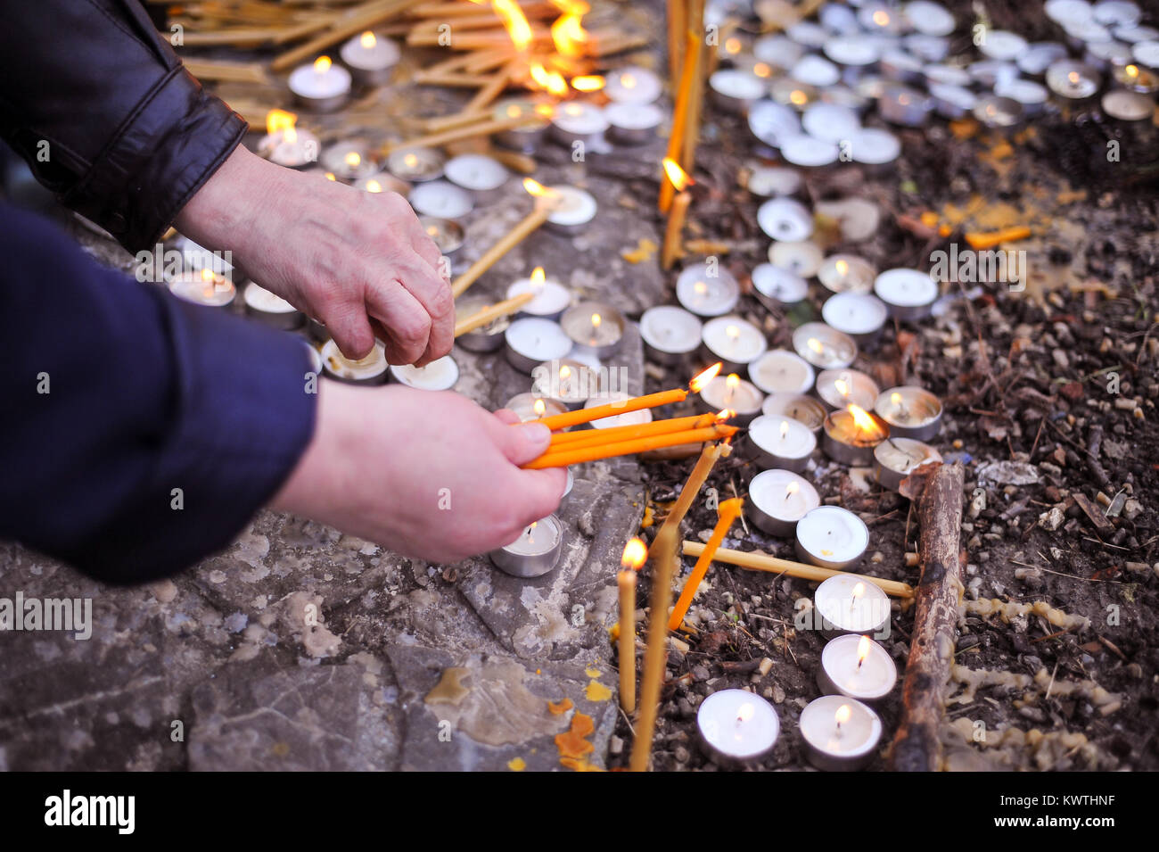 People light candles in a church yard celebrating an christian orthodox ...
