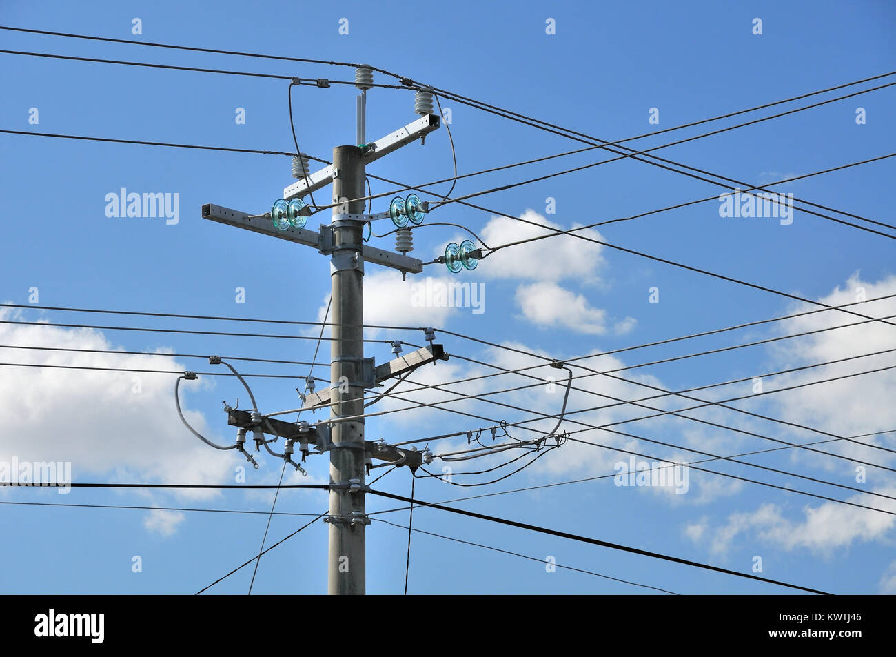 Complex network of electrical power cables isolated against sky ...