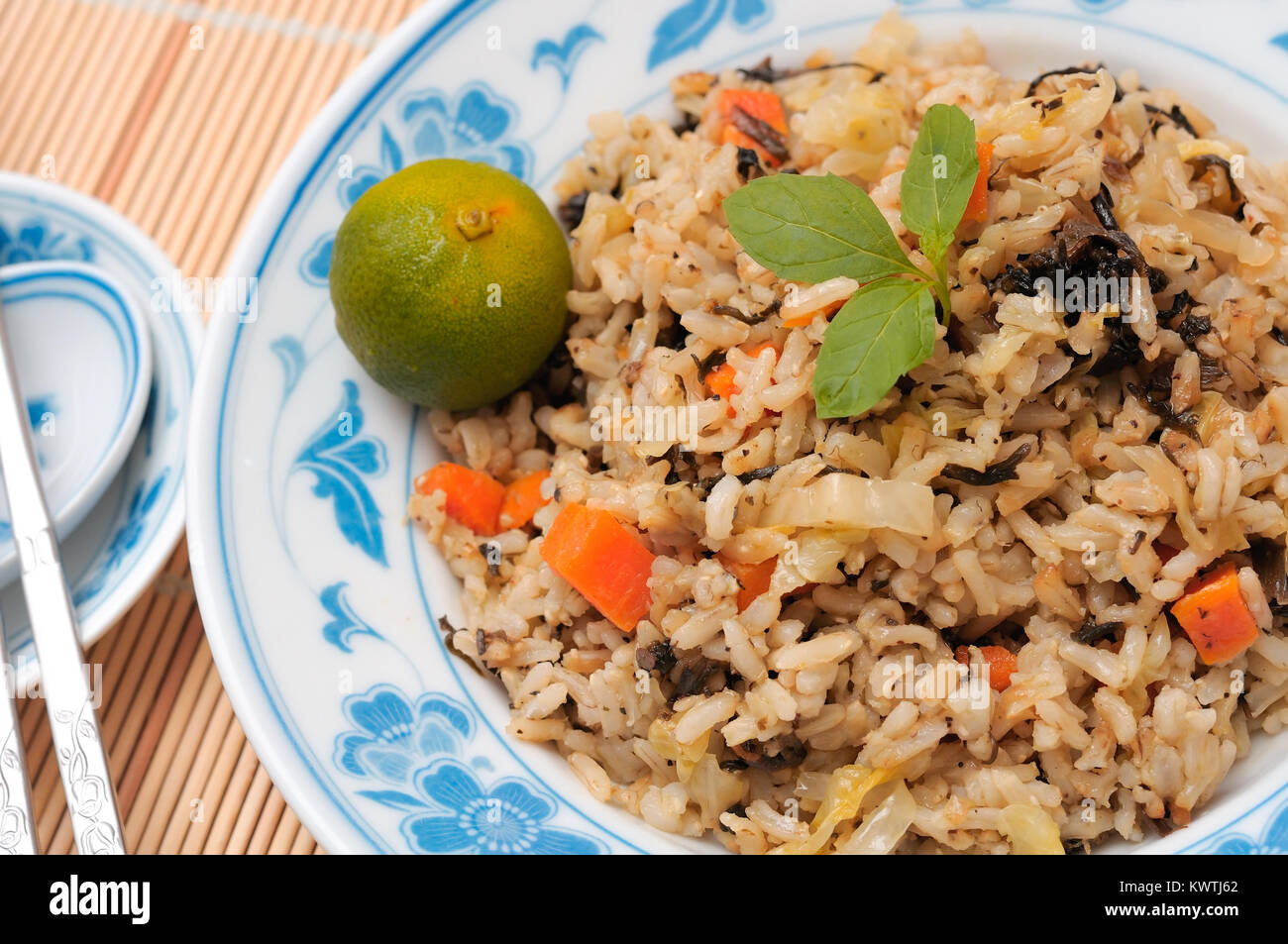 Vegetable fried rice with healthy Asian ingredients with lime on plate ...