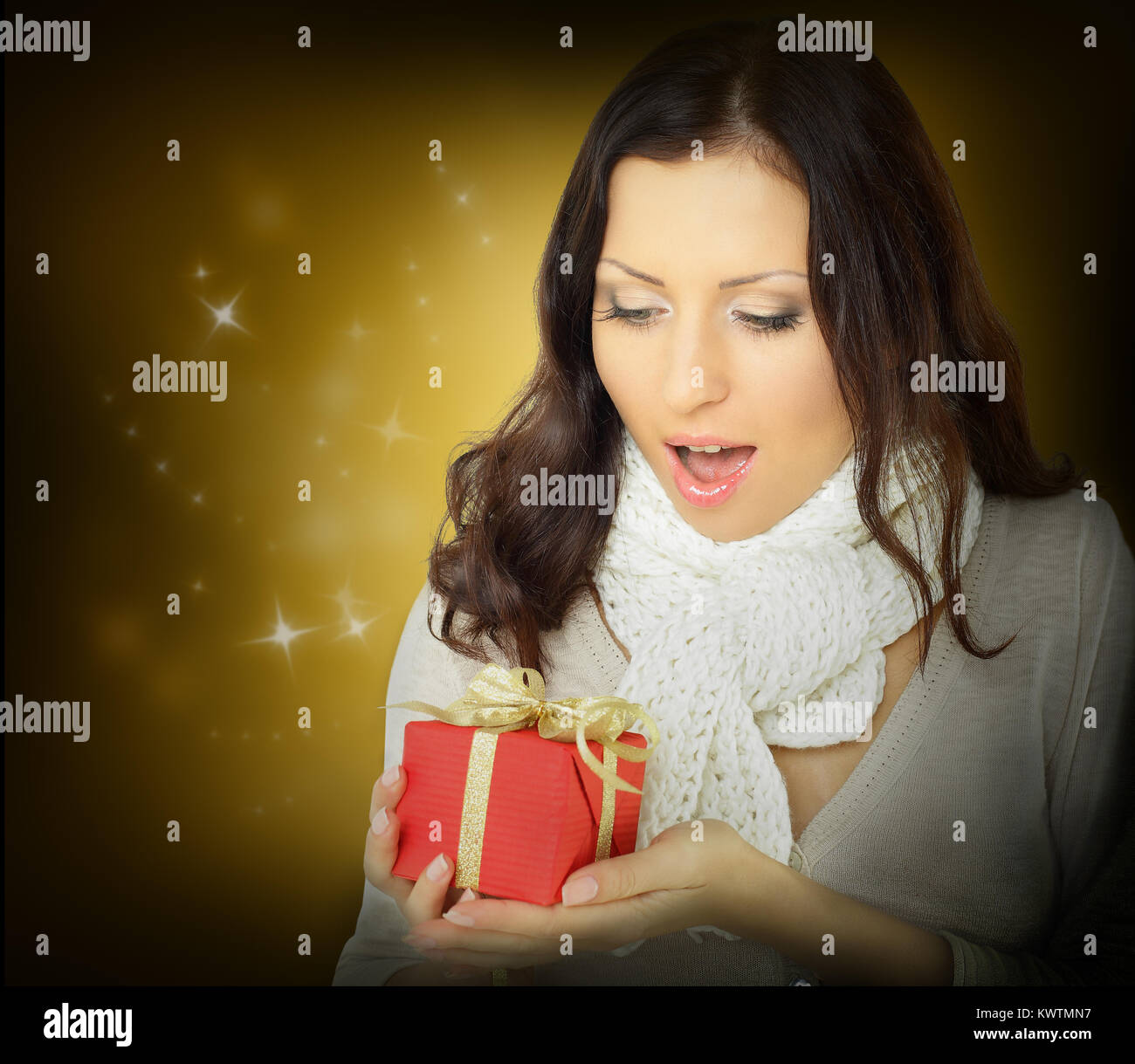 Surprise woman with Christmas gift Stock Photo - Alamy