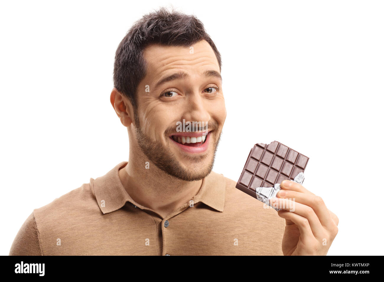Young guy holding a bitten chocolate bar and smiling isolated on white ...