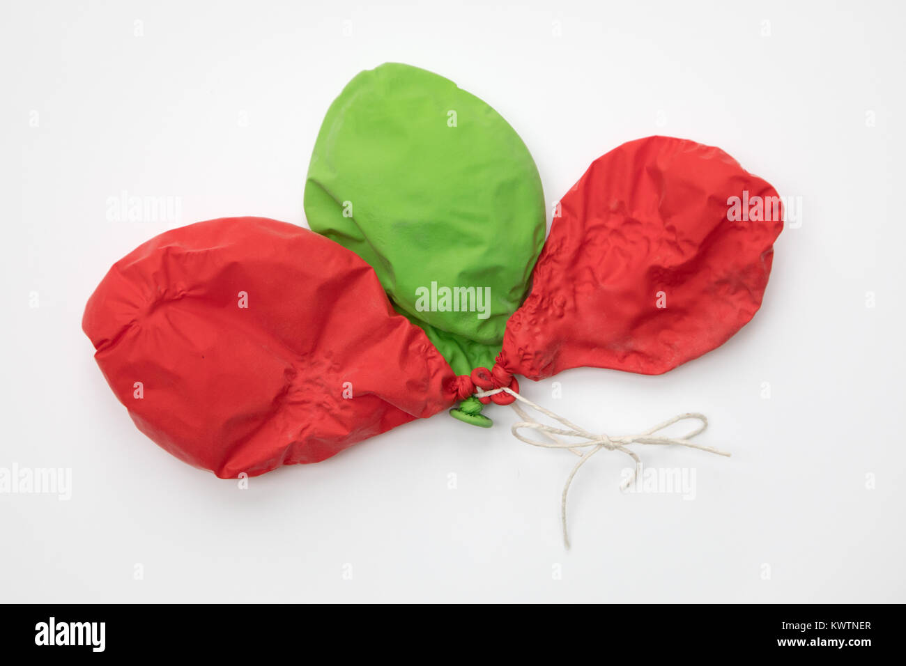 A bunch of three deflated party balloons Stock Photo - Alamy