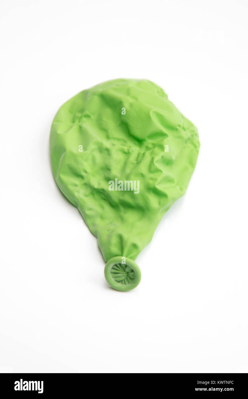 A deflated green party balloon Stock Photo - Alamy