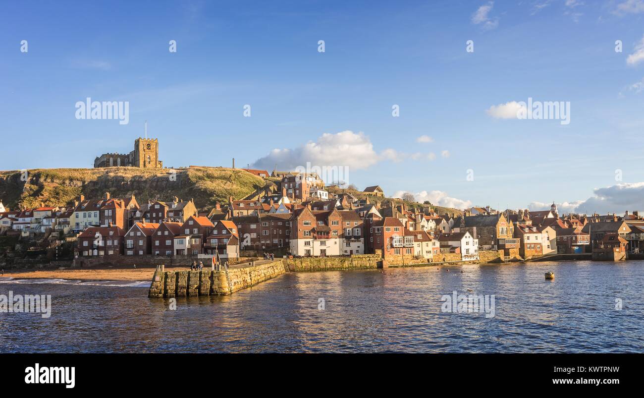Scenic view of Whitby across the harbour to the church on top of the ...