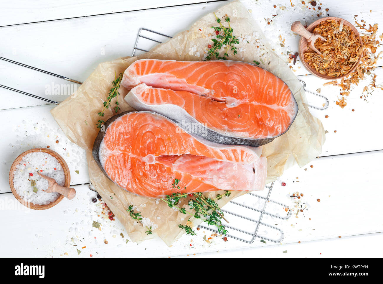 Raw salmon steak on white wooden table top view Stock Photo - Alamy