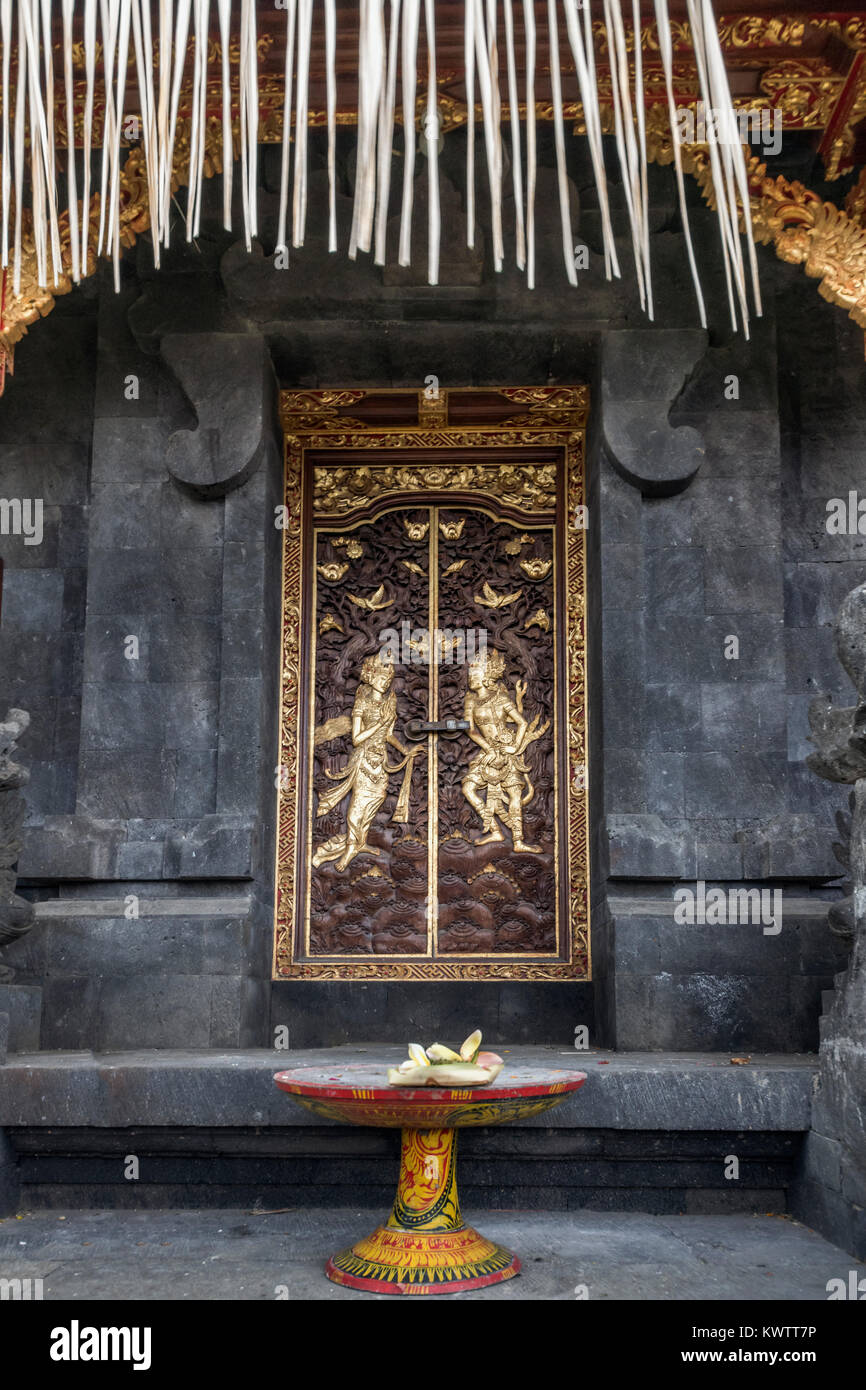 Gilded bas relief door on a pavilion (bale) and offerings, Pura ...