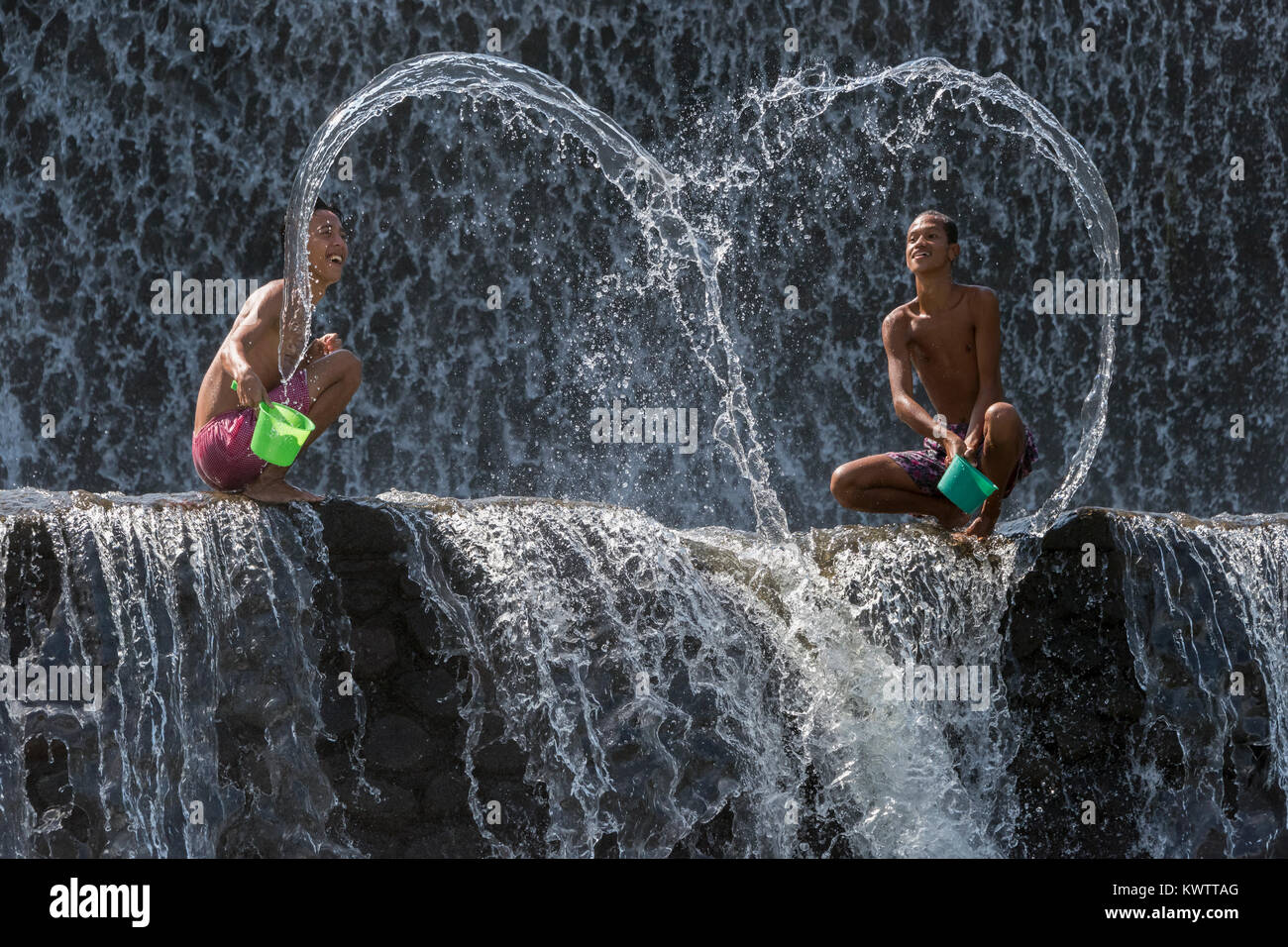 Water heart made by boys playing in the water at Tukad Unda dam on a ...