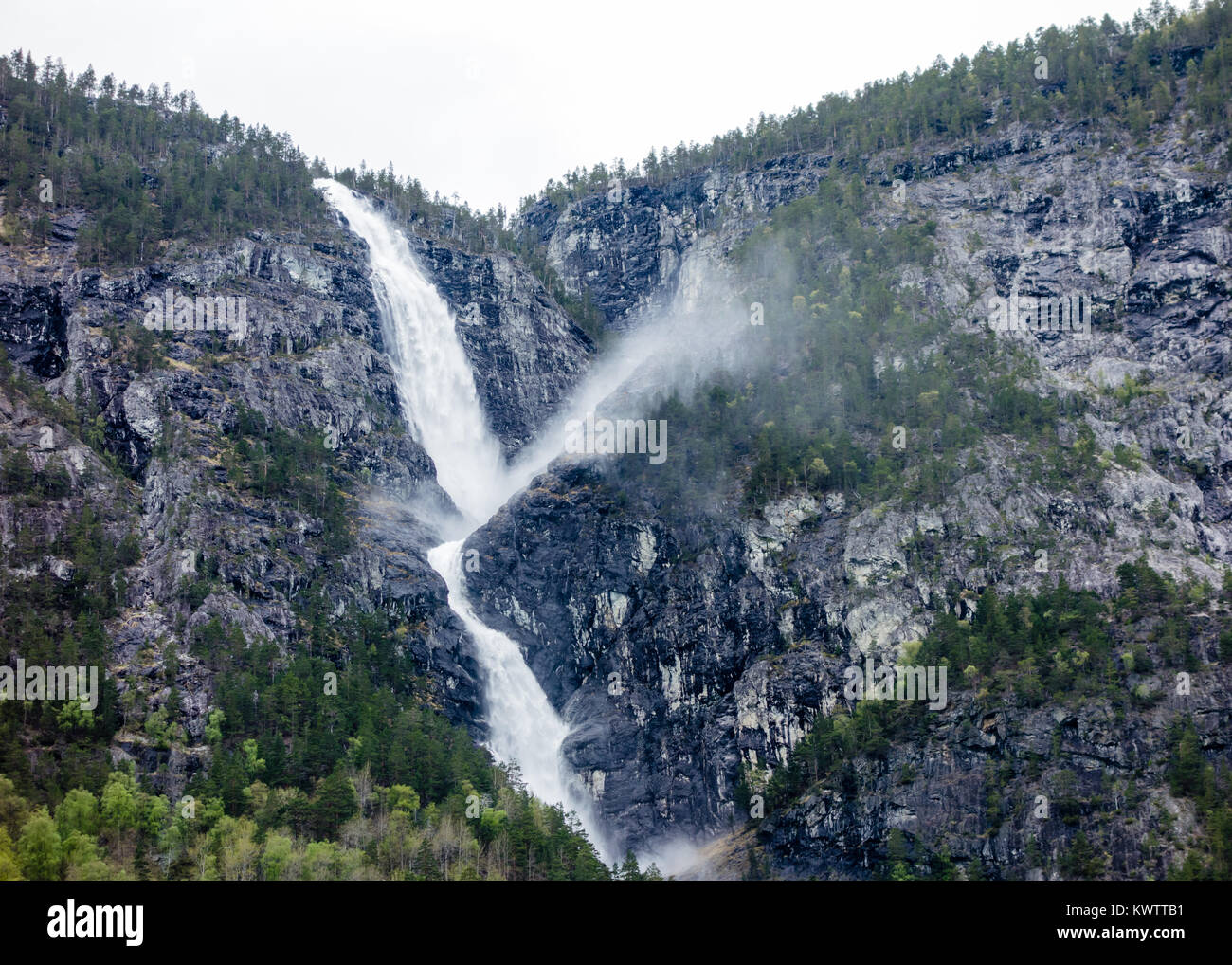 Waterfall cascading down steep cliffs near the Sognefjord in Norway ...