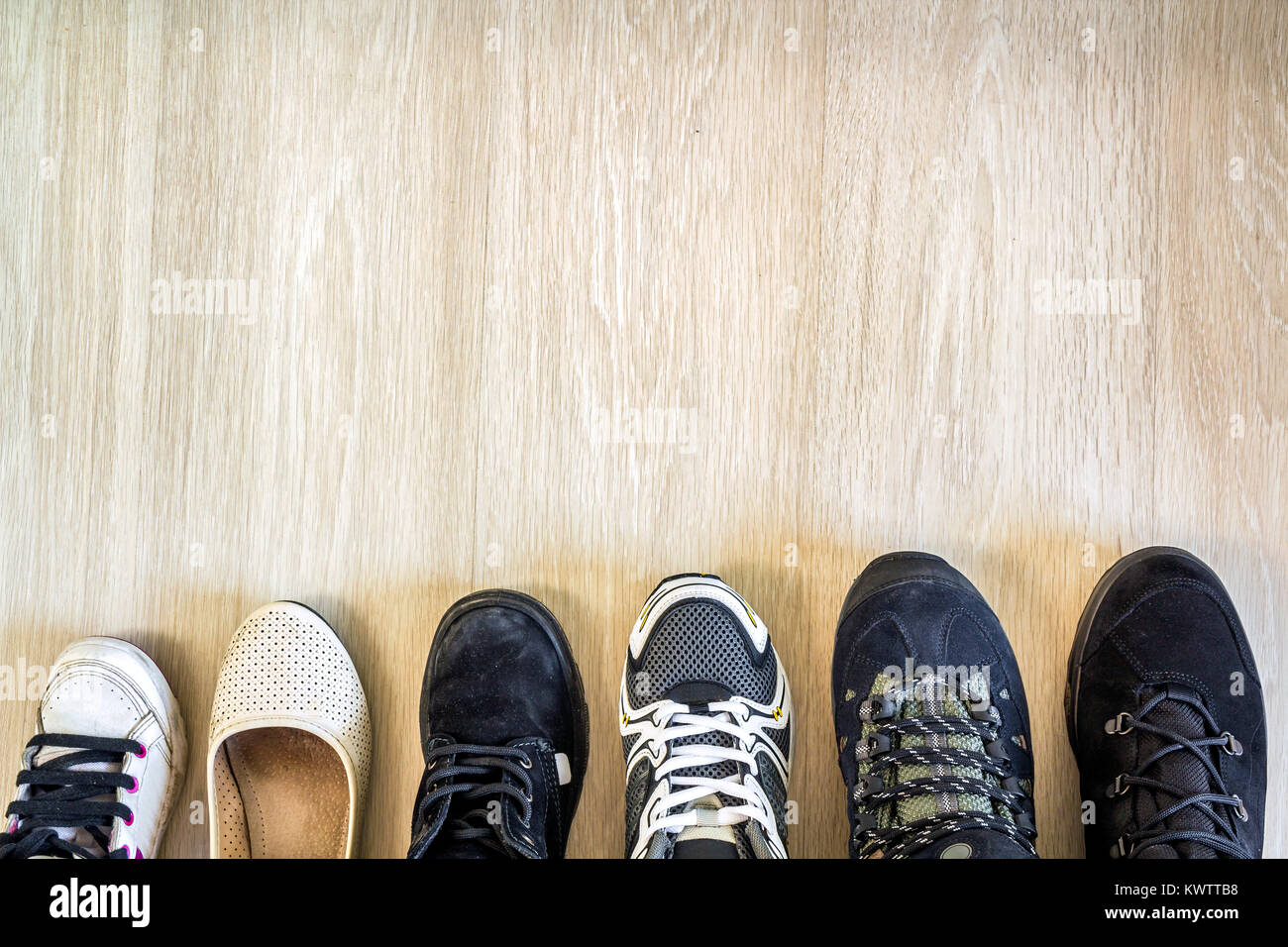 Different modern fashionable shoes on wooden background with copy space ...
