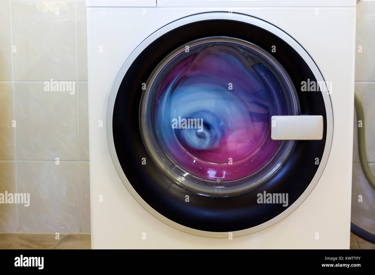 Colorful clothes and towels in washing machine Stock Photo - Alamy