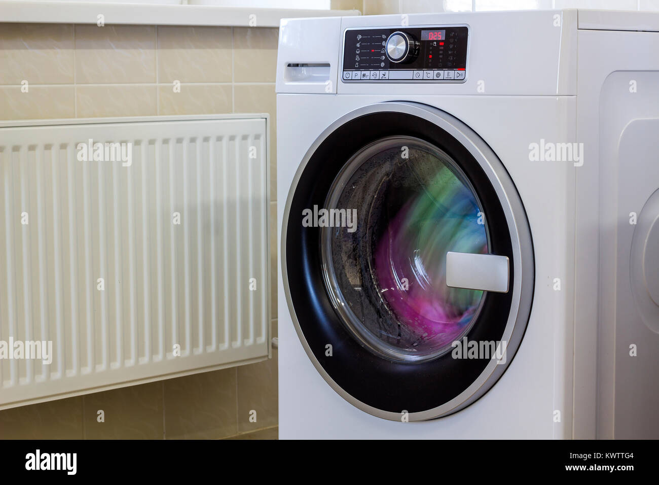 Colorful clothes and towels in washing machine Stock Photo - Alamy